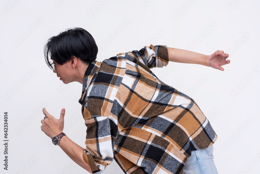 Foto de Side view of a young chinese man running in an exaggerated way ...