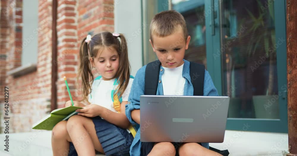 School small students friends outdoors using laptop computer . Kids ...