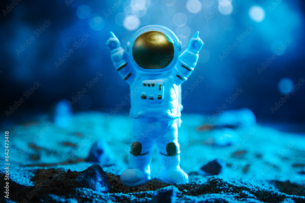 Astronaut in a space suit raised his hands in a sign of welcome on ...