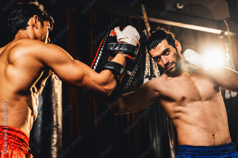 Asian and Caucasian Muay Thai boxer unleash punch in fierce boxing ...