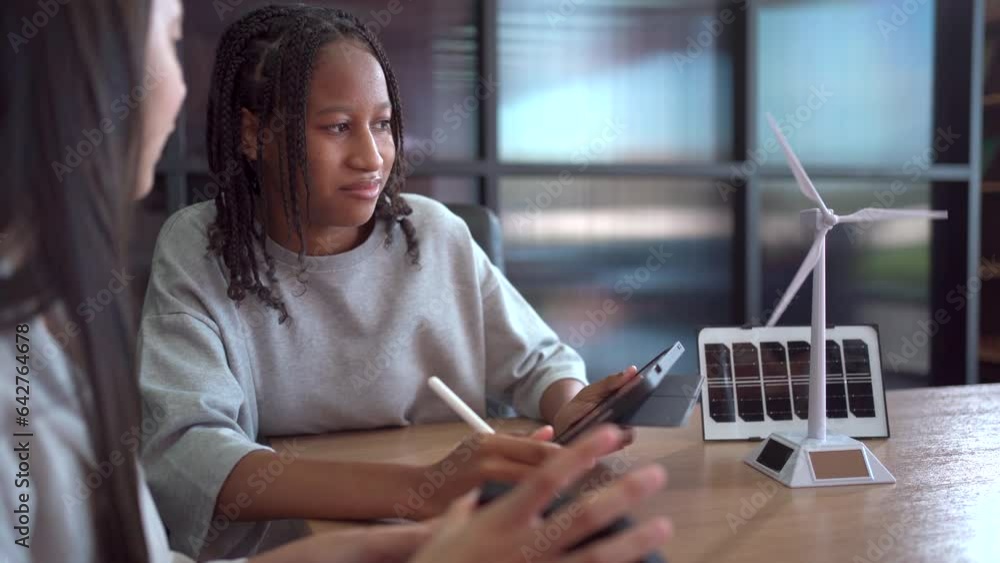 Group of primary school student learning and discussing about renewable ...