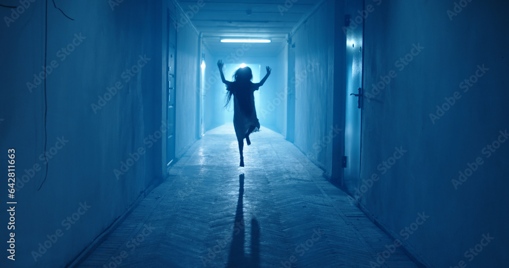 Little girl in white dress looking like a ghost carelessly running down ...