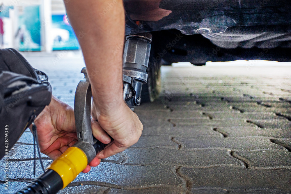 man's hand puts on a gas gun for refueling an LPG machine. The Economy ...