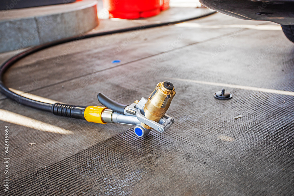 gas gun at a gas station for refueling a car with gas. World economic ...