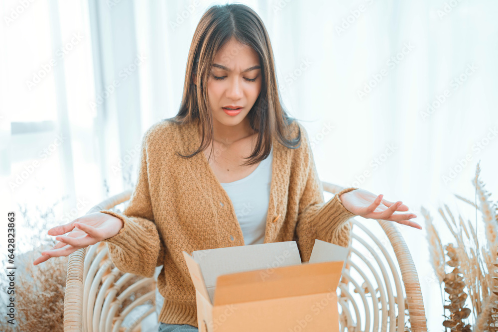 Bad delivery service, Dissatisfied young asian woman unpacking ...