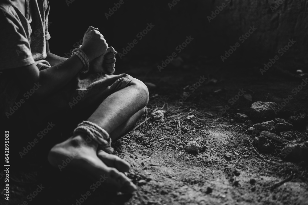 Silhouette of a boy with his hands and legs tied with rope. Missing ...