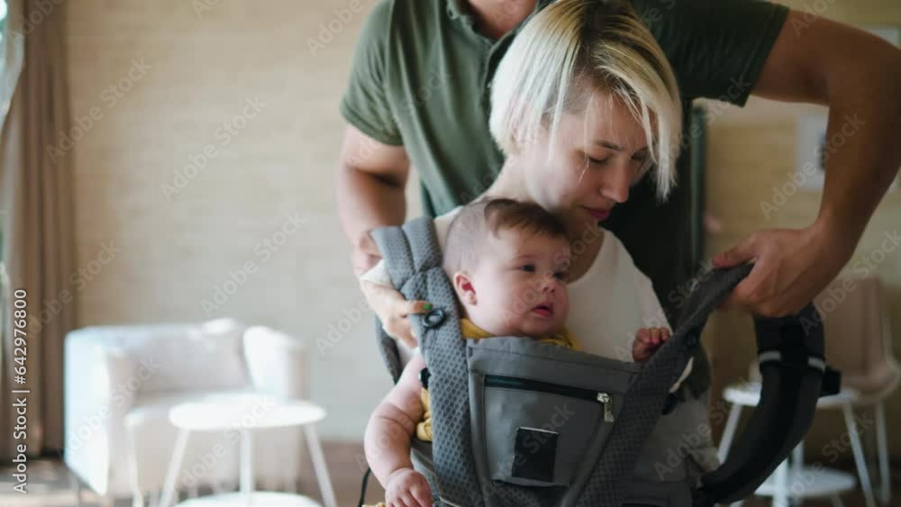 Young husband helps a woman with Phocomelia syndrome put baby daughter ...