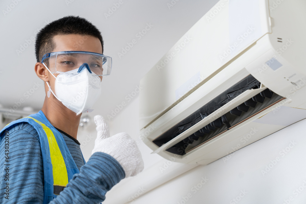 Professional male staff cleaning, air conditioning, inspection and ...