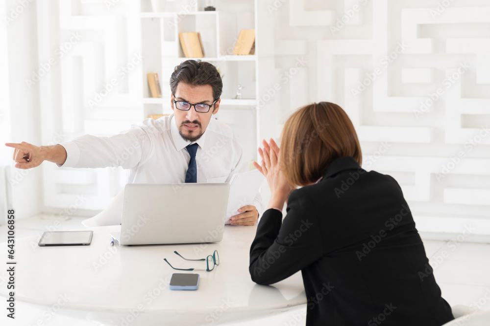 Foto de Angry male boss firing his female worker and pointing on the ...