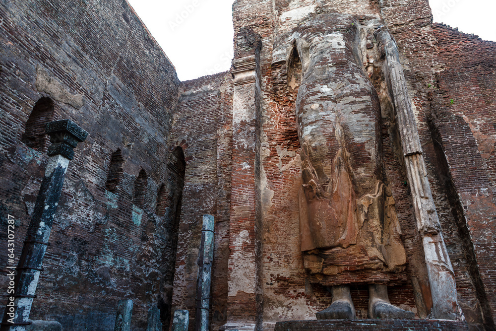 A giant masoned standing Buddha statue without head in a temple in the ...