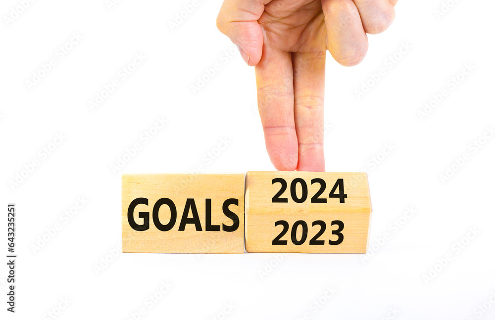 Planning 2024 goals new year symbol. Businessman turns a wooden cube ...