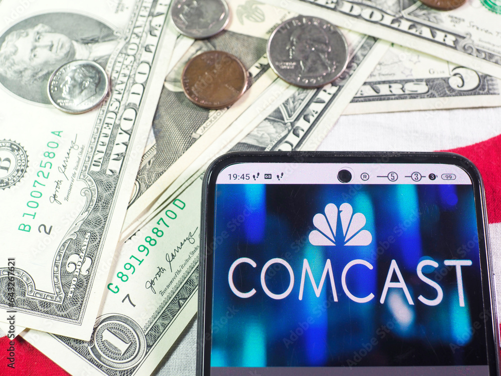 In this photo illustration, Comcast Corporation logo is seen displayed ...