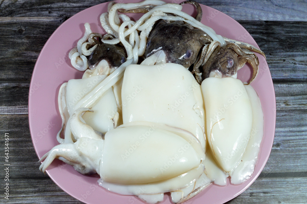 Fresh raw uncooked squid, a mollusc with an elongated soft body, large ...