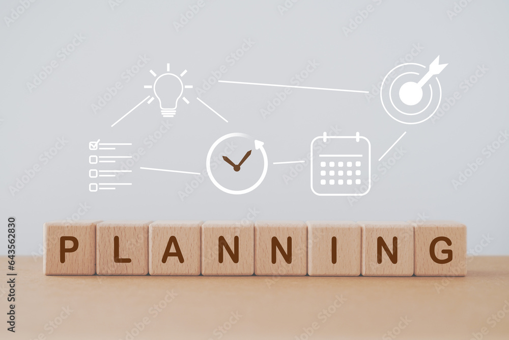 PLANNING text on wooden cube blocks and checklist, lightbulb, clock ...