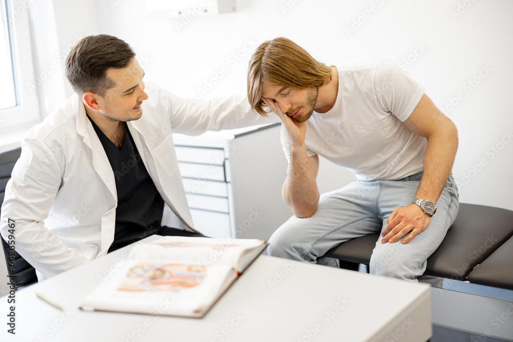 Sad man having some problems with men's health sitting on medical ...