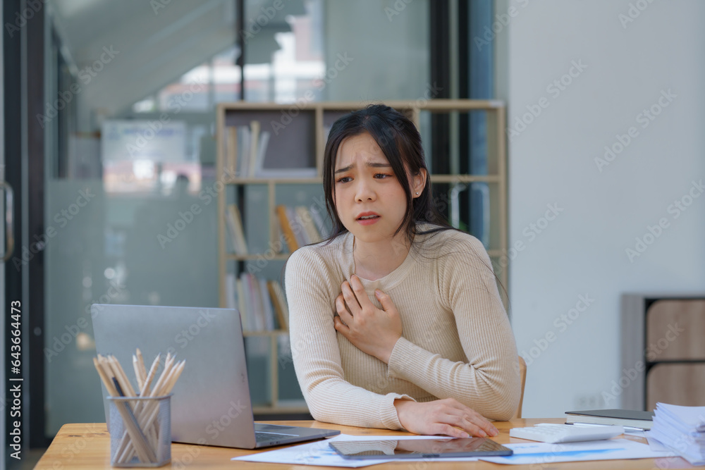 An Asian female has a heart attack pain, and tension-sick employee who ...