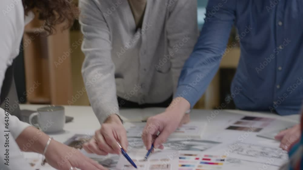 Group of experienced male and female architects standing around an ...
