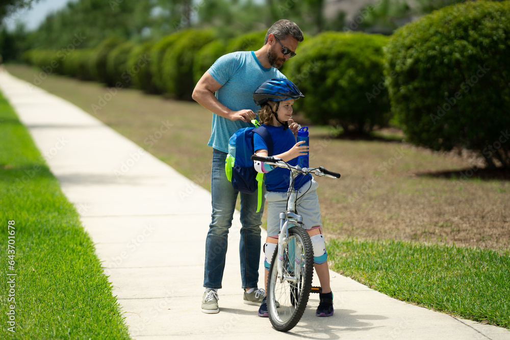 Father and son concept. Father teaching son riding bike. Father helping ...