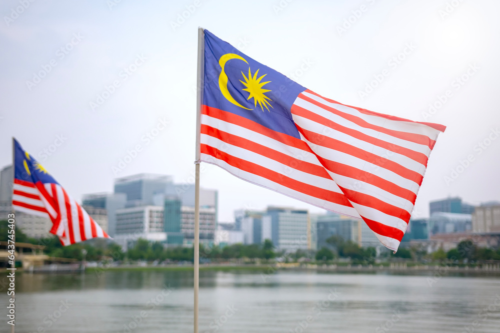 The Malaysia flag is also known as Jalur Gemilang waving with a city in ...