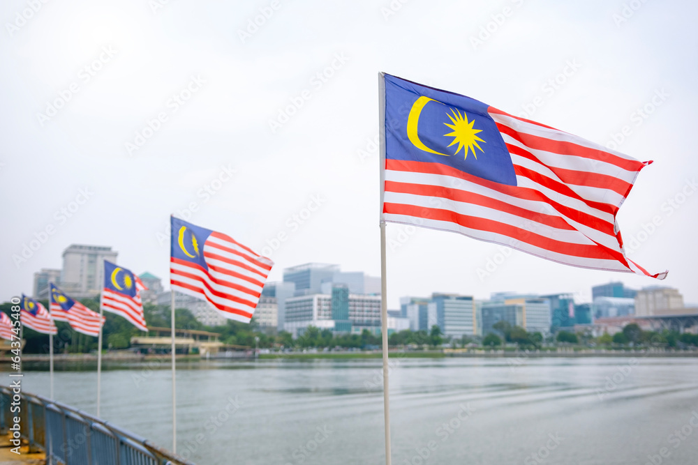 The Malaysia flag is also known as Jalur Gemilang waving with a city in ...