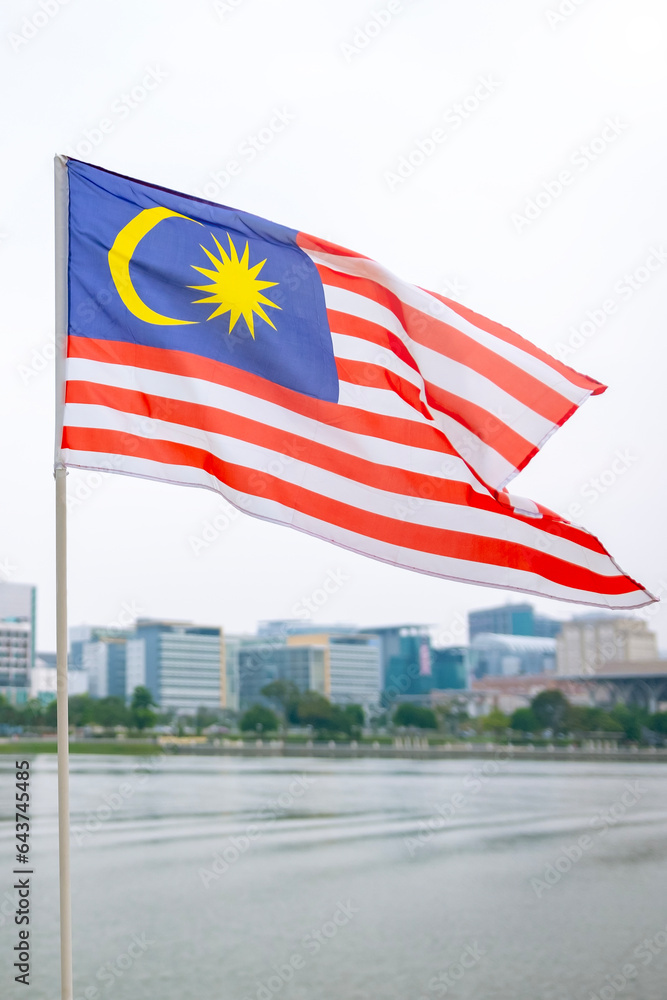 The Malaysia flag is also known as Jalur Gemilang waving with a city in ...