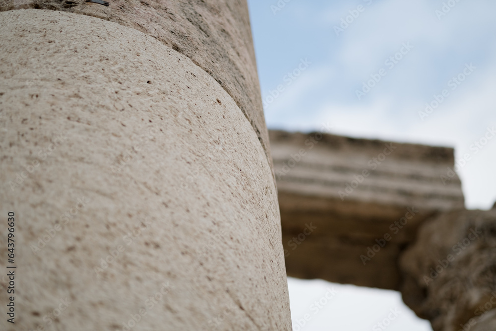 An enormous, tall marble column still stands tall at an ancient Roman ...