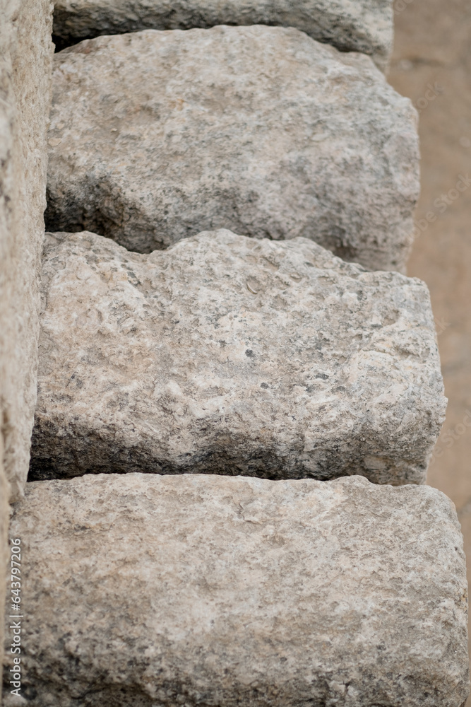 Massive stone blocks are lined up at the base of the wall of an ancient ...