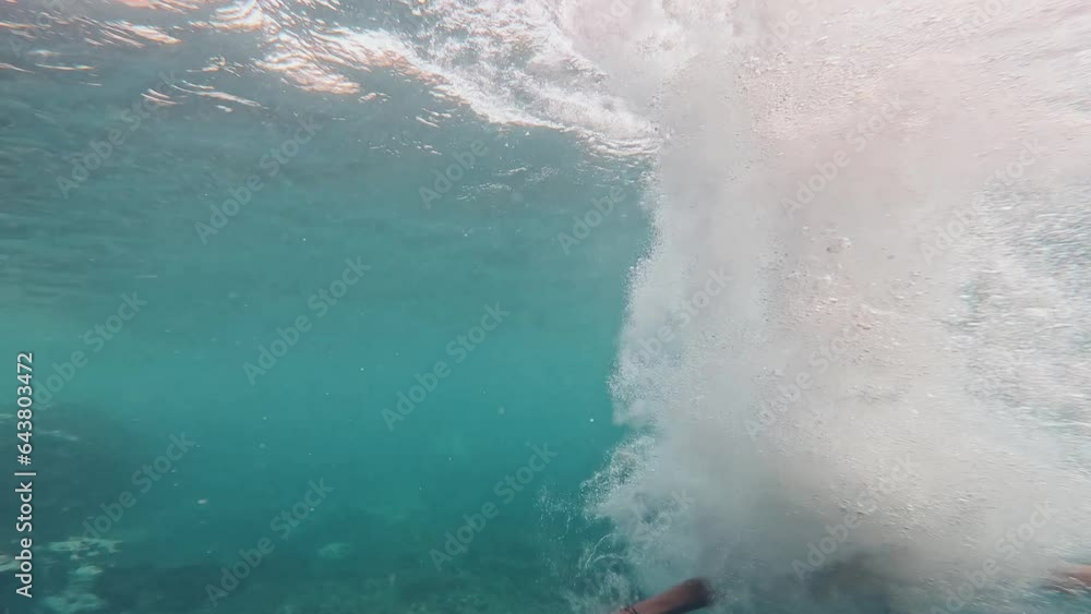 Close up of one young girl jumping in to the water of the sea from a ...