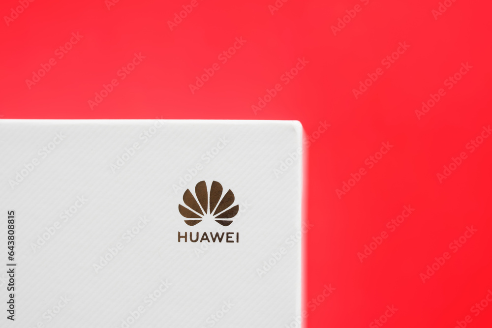Huawei label on a fragment of a white original box with a gadget. Red ...