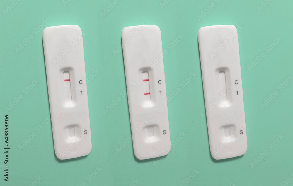 Set of three rapid antigen tests (RAT). The tests are showing a ...