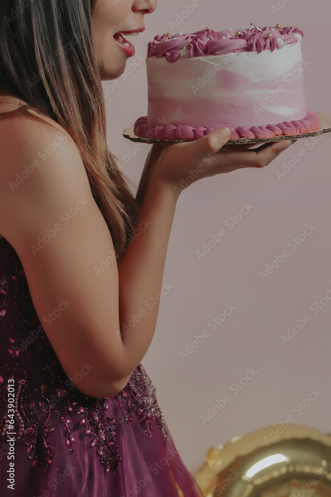 Portrait of a woman in a purple dress, celebrating her birthday with a ...