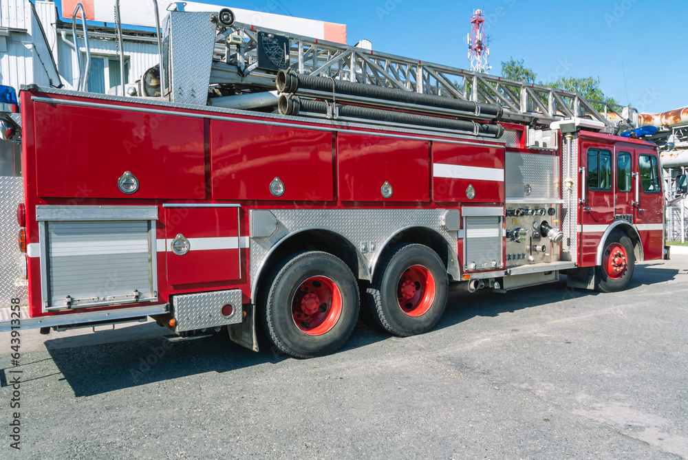 A fire truck with a retractable ladder for extinguishing fires at a ...