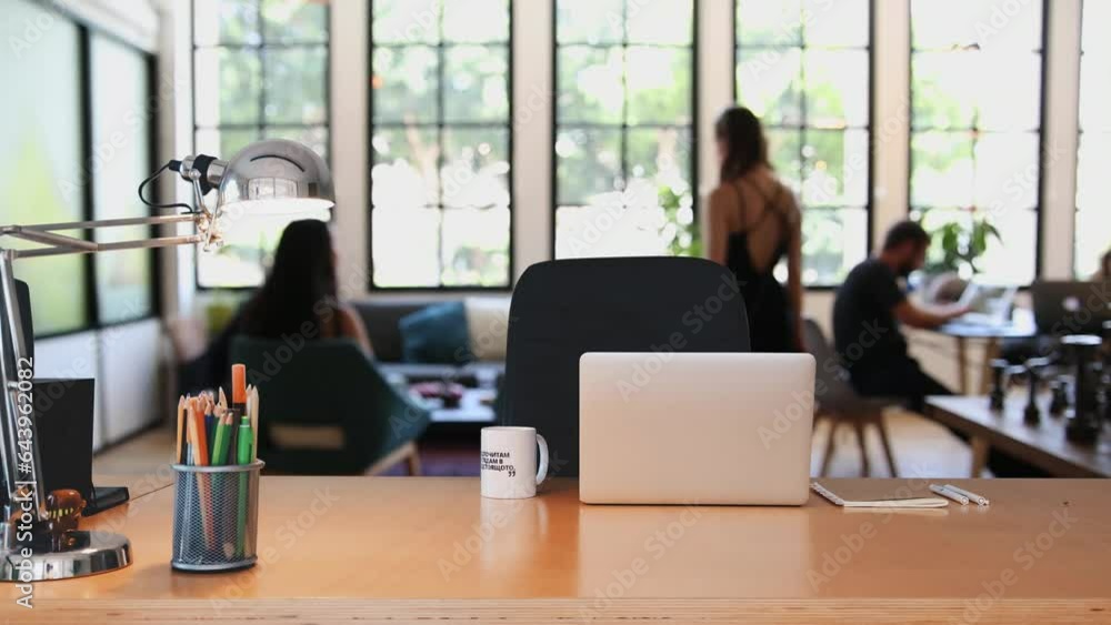 Capture the bustling energy of an office work desk scene with people ...