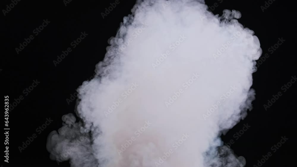White smoke on a black background in slow motion. Explosion steam ...