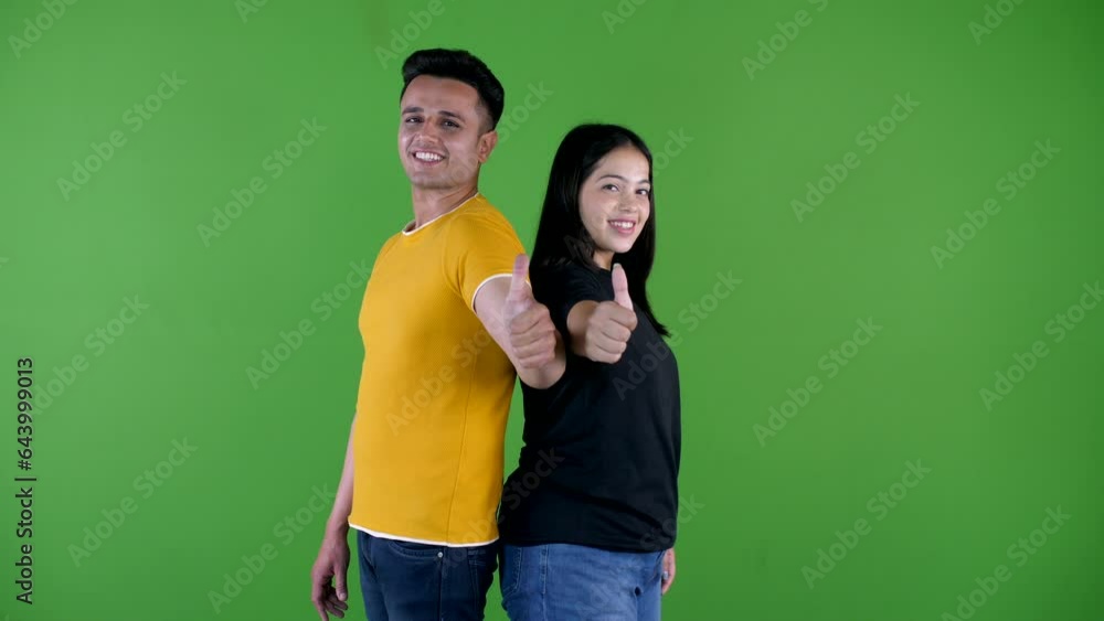 A handsome man and a beautiful woman is showing thumbs up with a smile ...