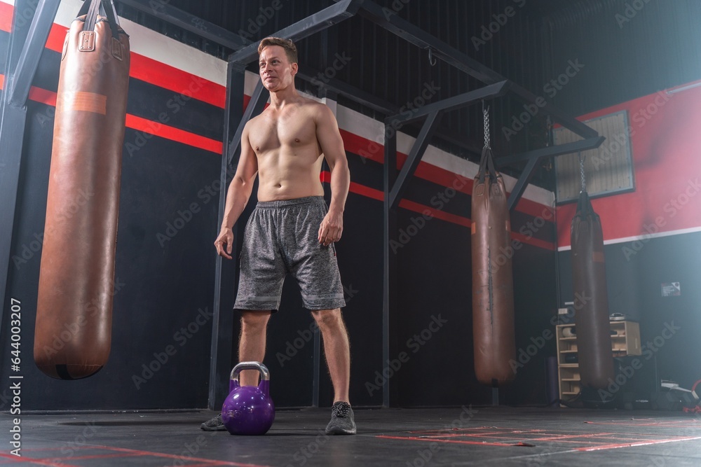 Handsome and muscular white man lifts heavy dumbbells, showcasing his ...
