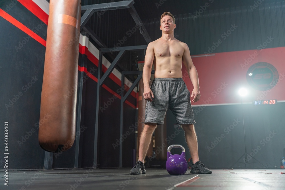 Handsome and muscular white man lifts heavy dumbbells, showcasing his ...