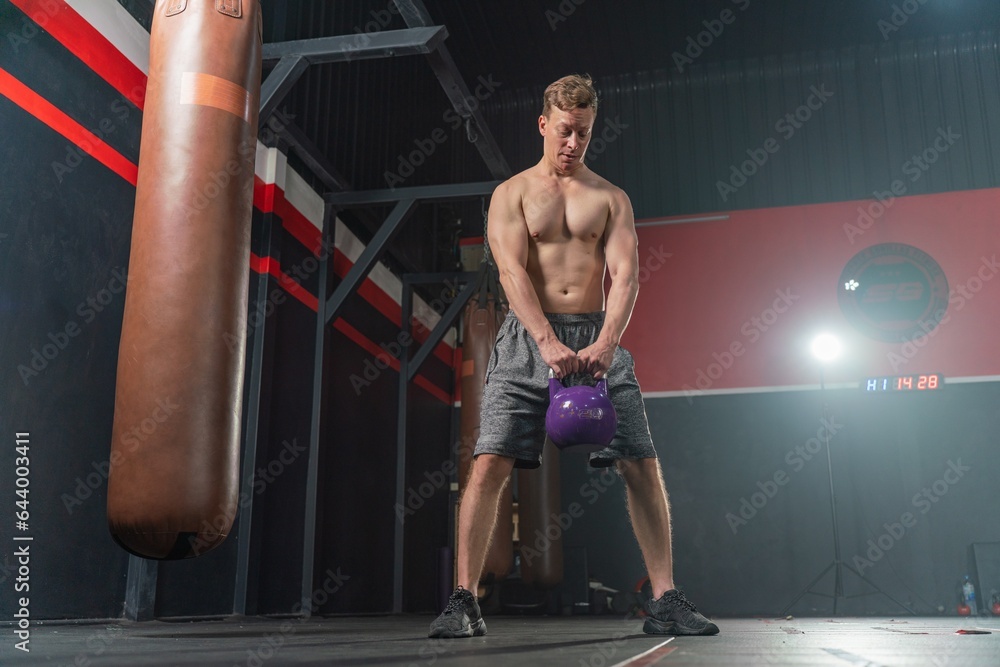 Handsome and muscular white man lifts heavy dumbbells, showcasing his ...
