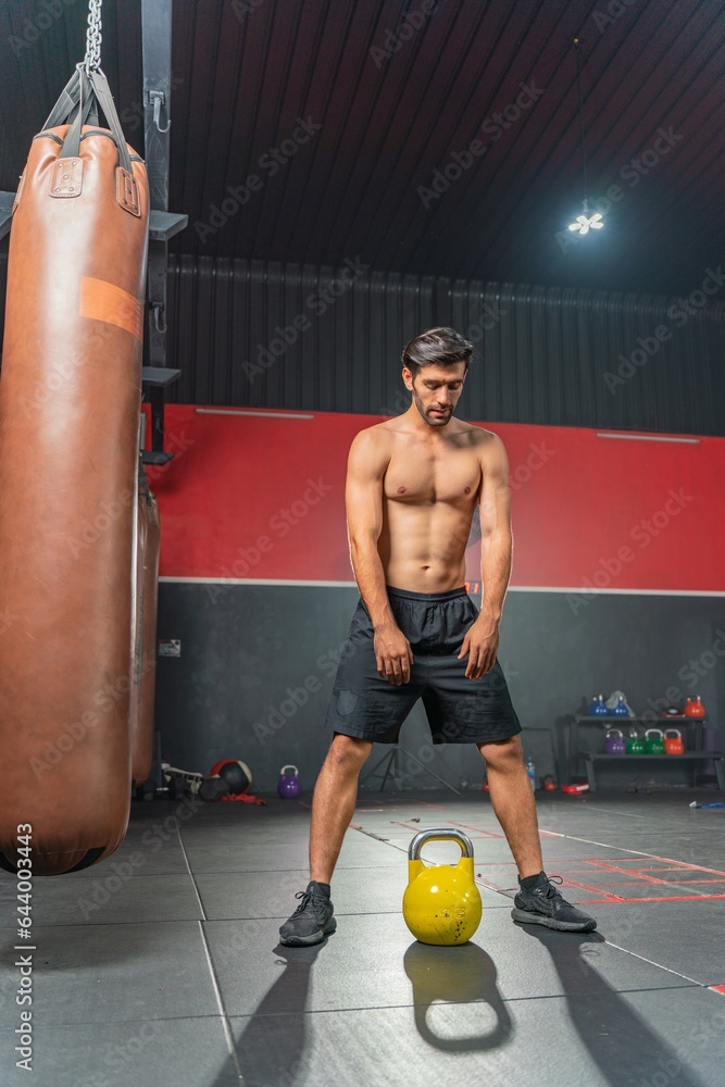 Handsome and muscular white man lifts heavy dumbbells, showcasing his ...