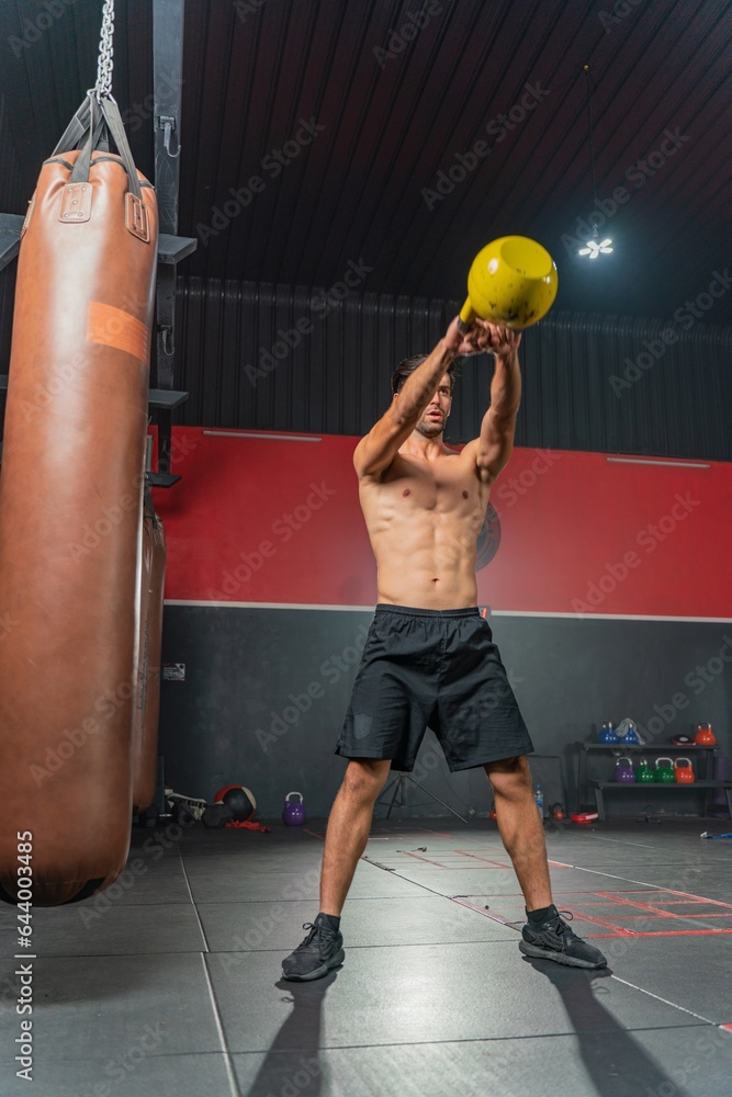 Handsome and muscular Middle Eastern man lifts heavy dumbbells ...