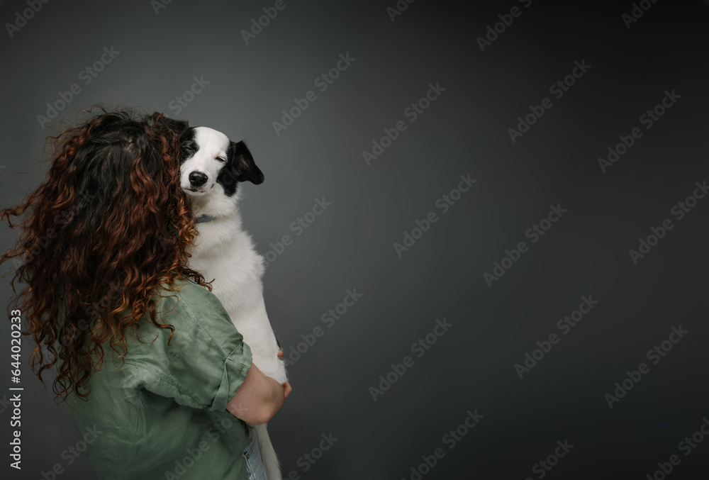 anxious dog face. woman with long curly hair holding hugging her calm ...