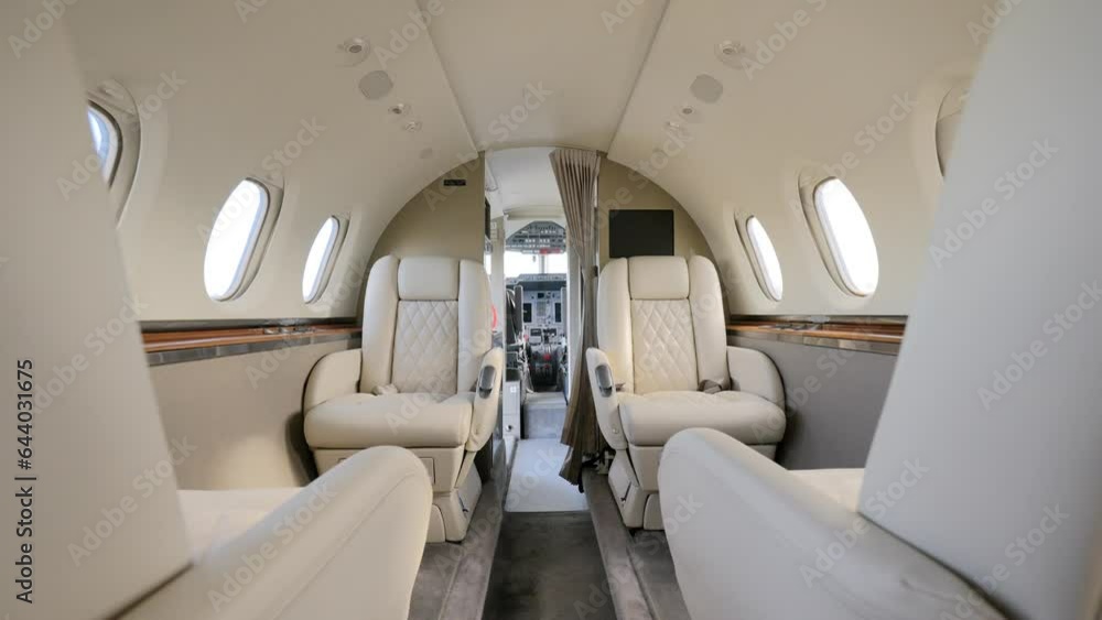 Exquisite interior of private vip aircraft with four white cozy leather ...