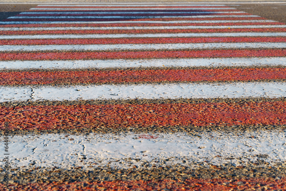 pedestrian crossing road markings, red and white lines on asphalt as ...