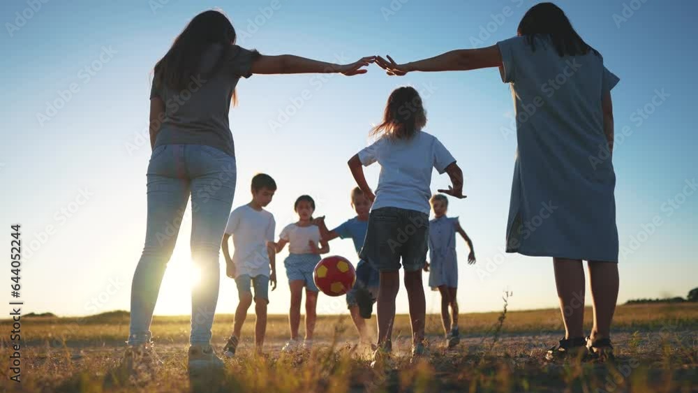 happy family playing ball in the park. a group of children playing ball in nature. happy family ...