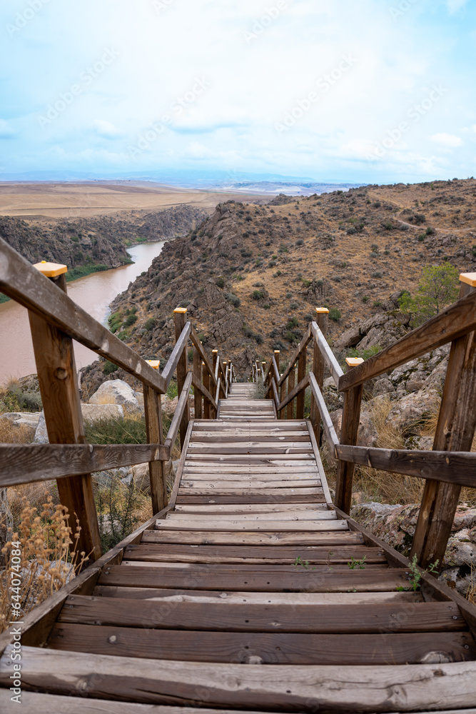 Wooden railing stairs descending from cliff to river Stock Photo ...