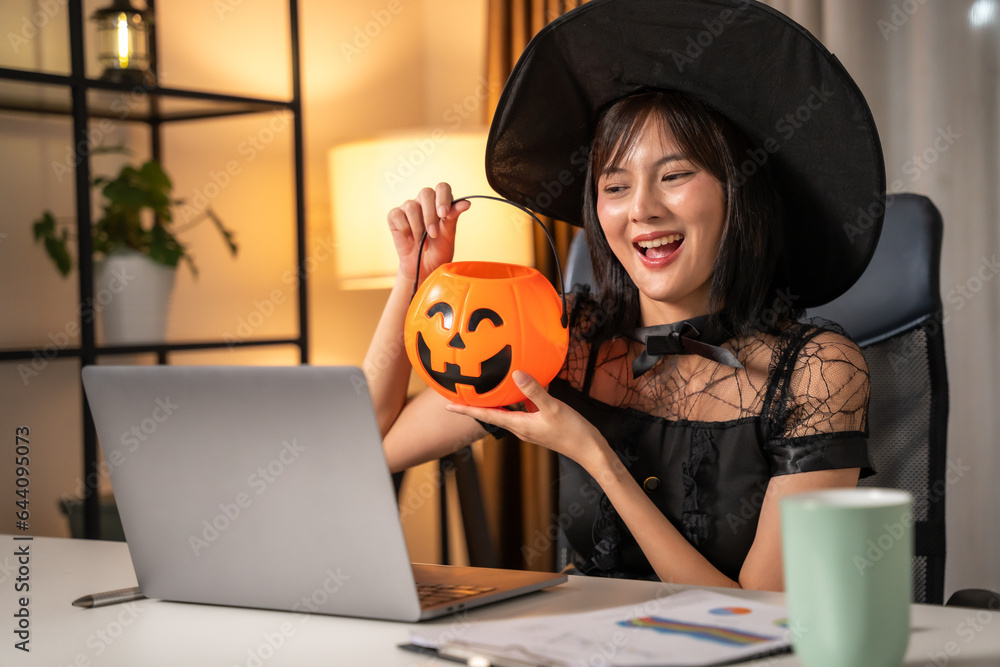 Female influencer wearing witch costume and live streaming at home. She ...