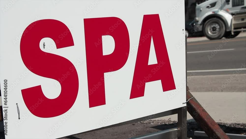 spa writing caption text sign signboard with road behind with traffic ...