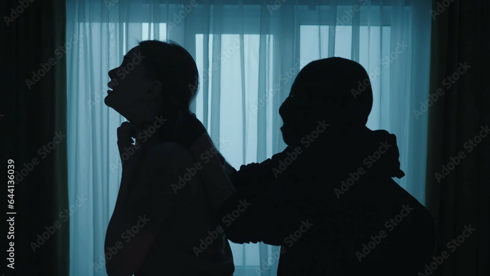 Defenceless and in danger. A robber strangles a defenseless woman with ...