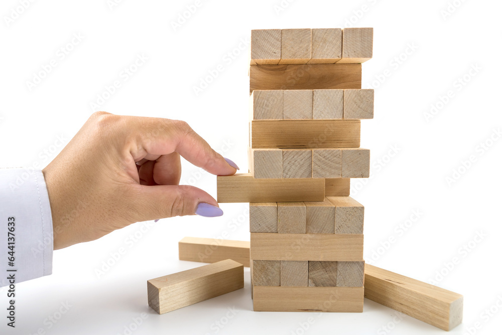 Building from wooden blocks. Wood blocks stack game with Hand on background. Conceptual of ...