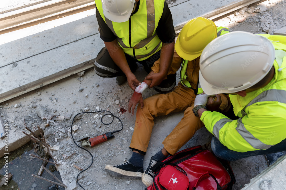 First aid team support to builder worker after hand injury bleeding ...